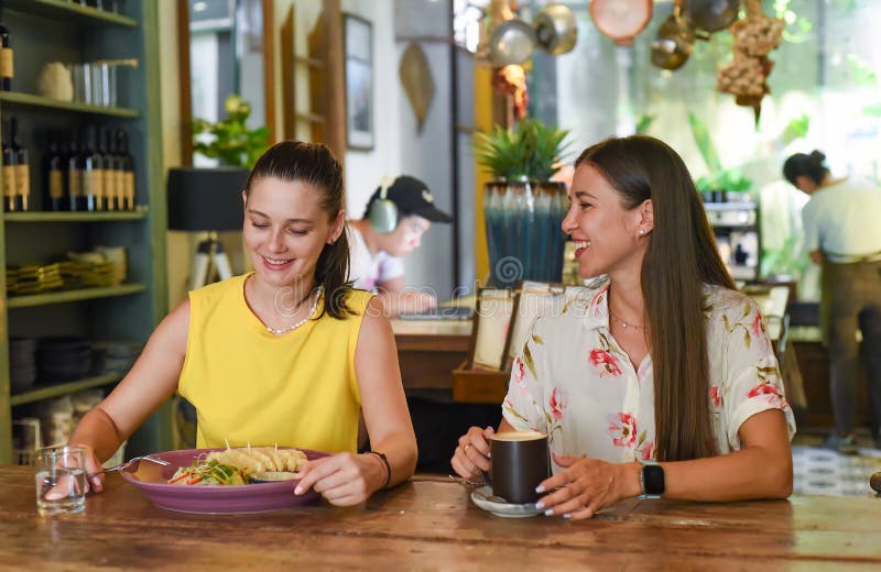 Two Best Friends Talking and Eating in a Cafe Stock Photo - Image of ...