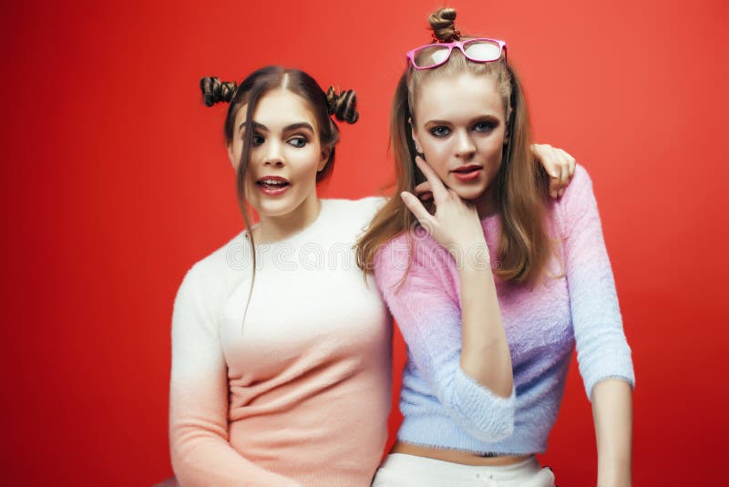 Two Best Friends Teenage Girls Together Having Fun Posing Emotional On Red Background