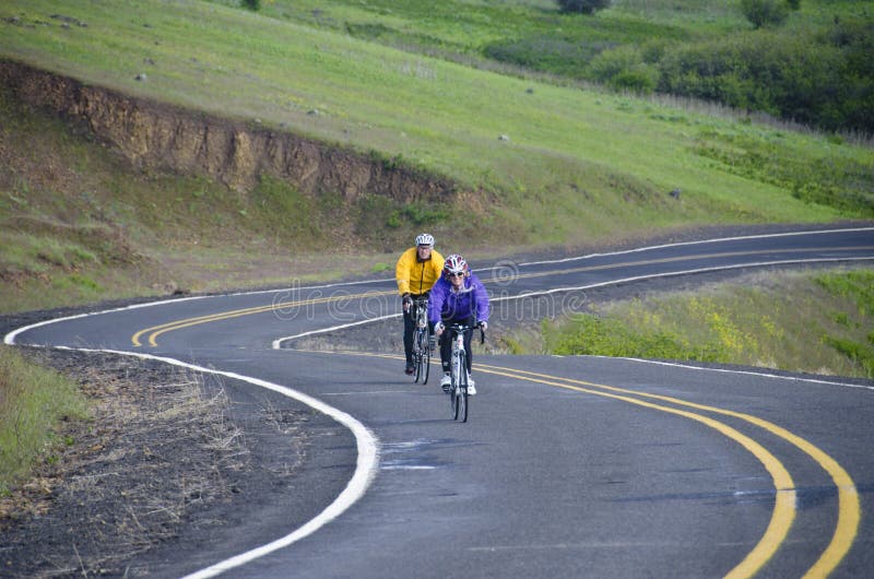 Two Bicycle Riders on Rural Road Stock Photo - Image of bike, asphalt ...