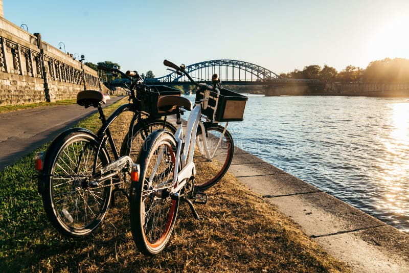 Two Bicycles at the Embankment on Sunset Stock Image - Image of ...