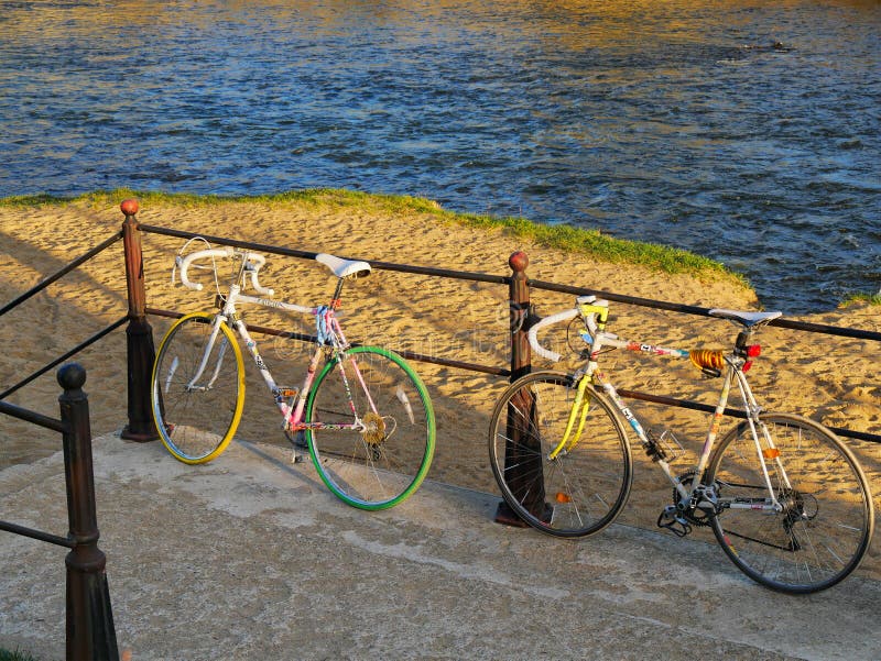 Two Bicycles Lean on a Railing by the River Editorial Stock Image ...
