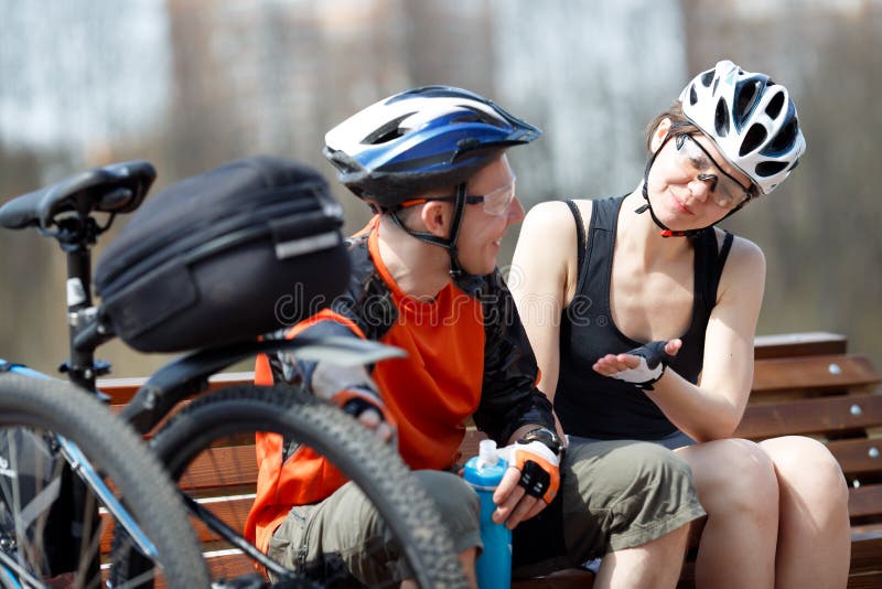 Two Bicyclists Resting on Bench Stock Photo - Image of biking, female ...
