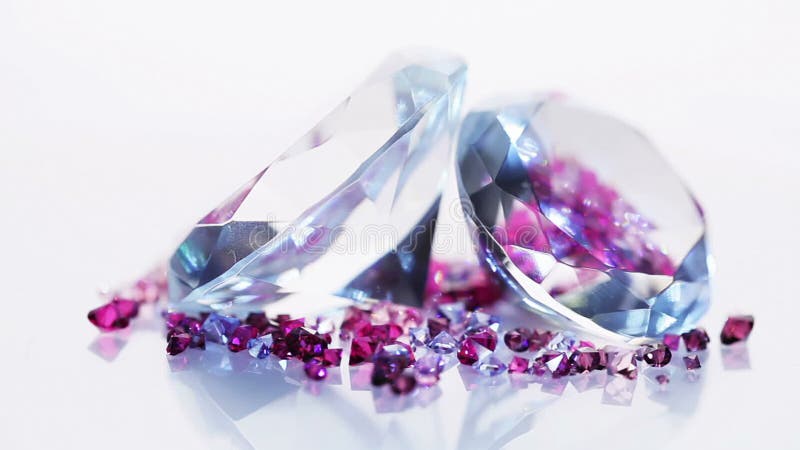 Two Big Diamonds with Many Small Gems Rotating Over White Stock Video ...