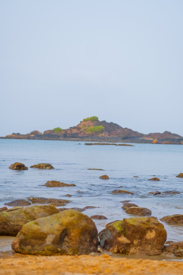 Two Big Rocks and Random Rocks in the Ocean Stock Image - Image of ...