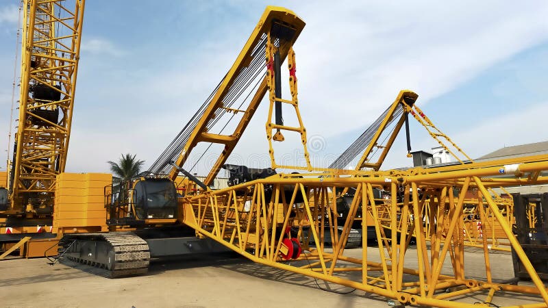 Two Big Yellow Crawler Crane Assembling the Boom and Setting Up Stock ...