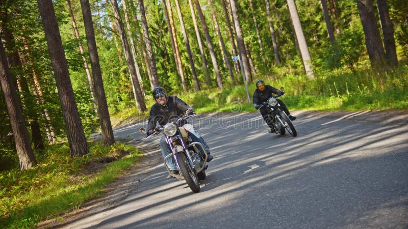 Bikers are Riding on the Road in the Forest Near Each Other Stock Photo ...