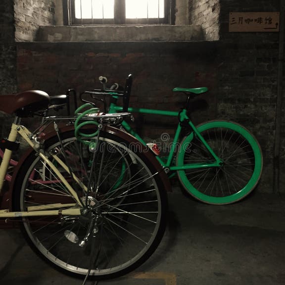 Two bikes under a window stock photo. Image of bikes - 56629024
