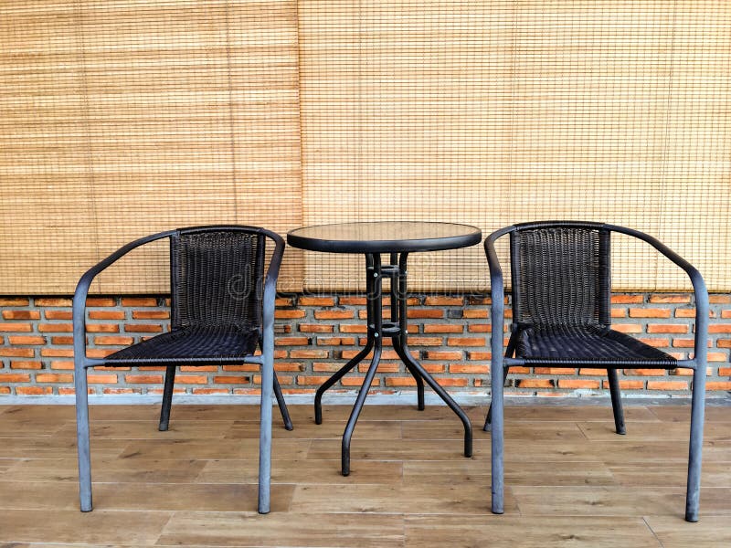 Two Black Chairs with Round Table on Wood Floor, Brick Wall and Stock ...