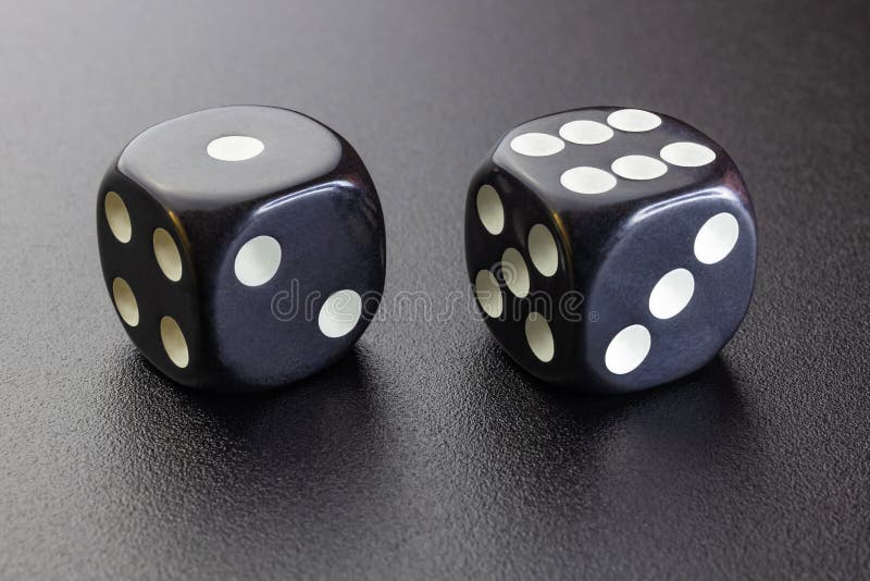 Two Black Dice Close-up on a Dark Illuminated Surface Stock Image ...