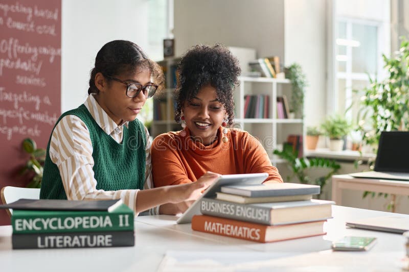 Two Black Girls Using Tablet in Class Stock Photo - Image of screen ...