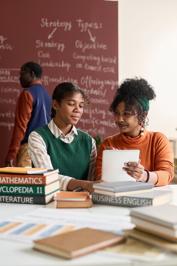 Two Black Girls Using Tablet Studying in Class Stock Image - Image of ...