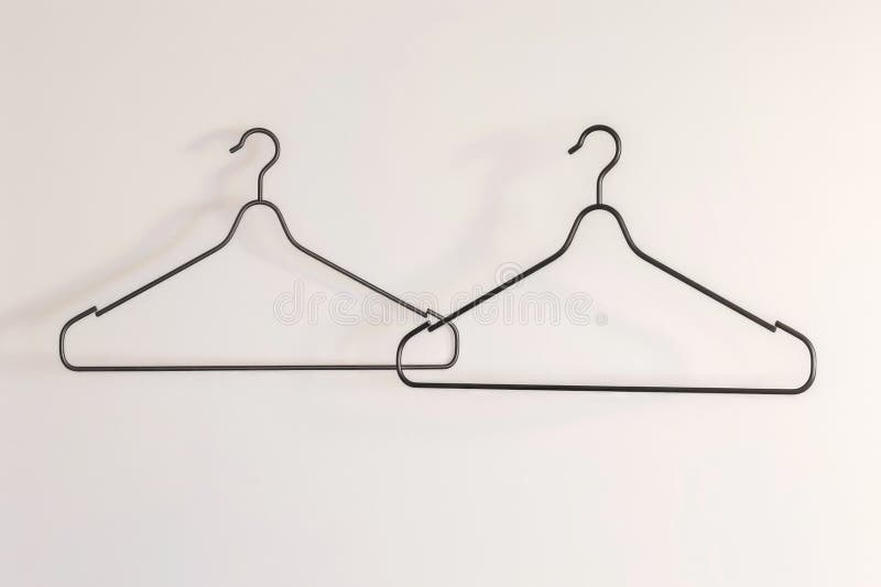 Two Black Hangers Attached To a White Wall, Simple and Minimalist ...
