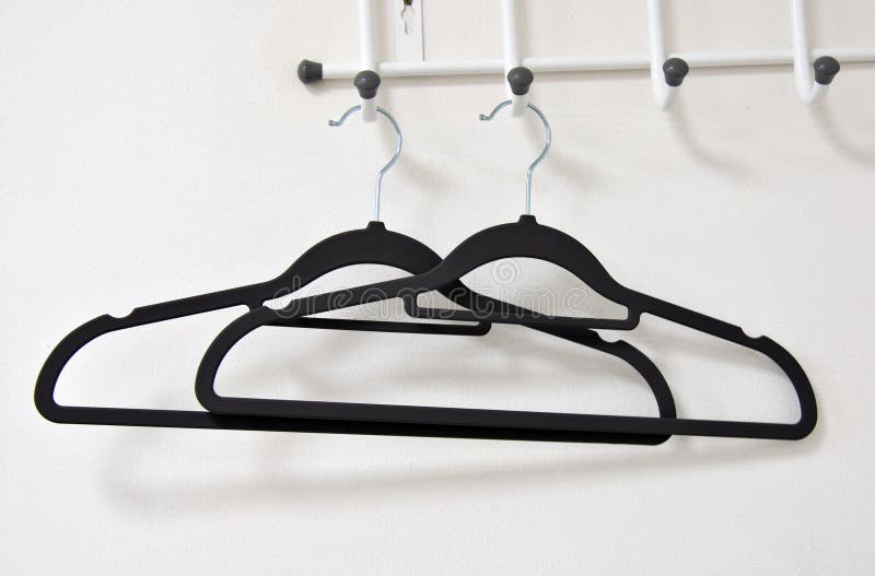Two Black Hangers Hanging on Hooks Stock Image - Image of wardrobe ...