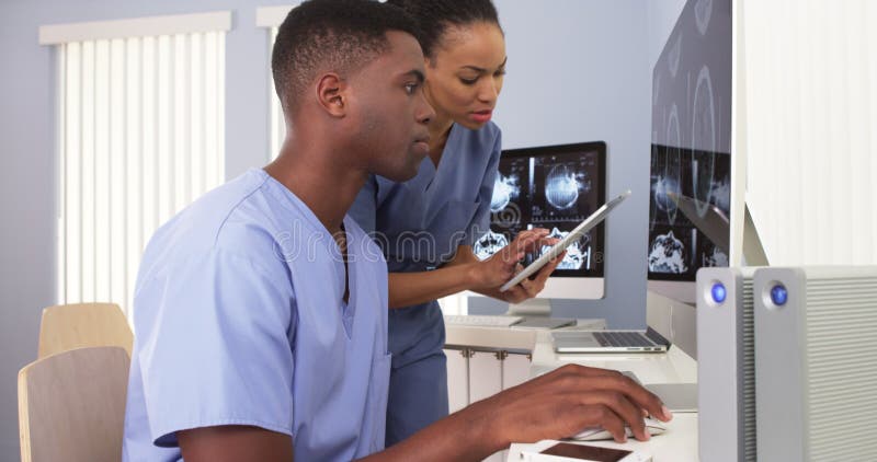Two Black Medical Specialists Working Together at Hospital Computer ...