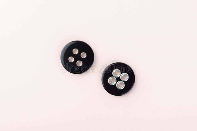 Two Black Plastic Buttons on Both Sides with Metal Inserts in the Holes ...