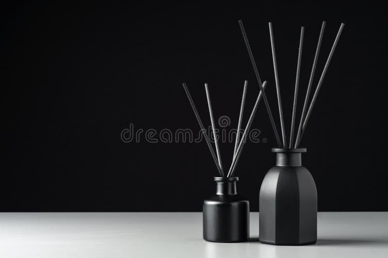 Two Black Reed Diffuser Bottles on White Surface Against Black Background Stock Photo - Image of ...