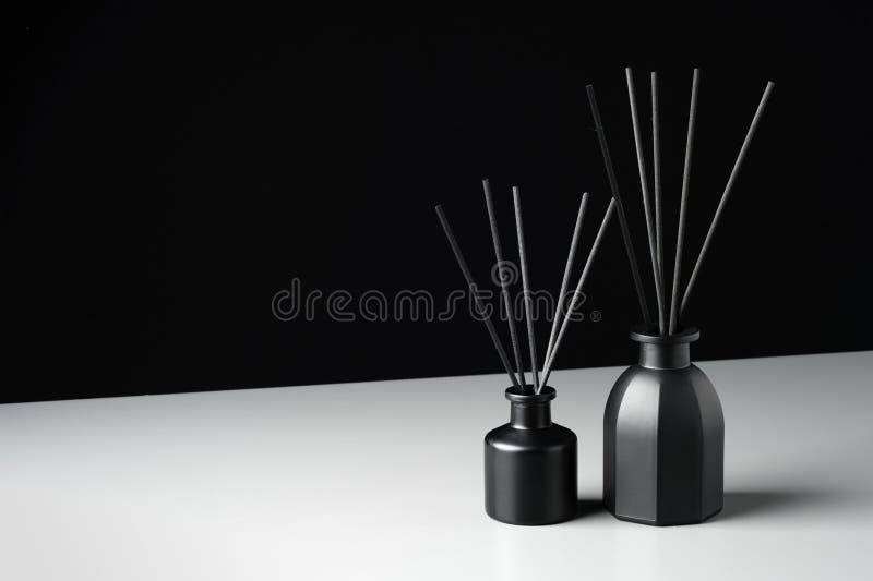 Two Black Reed Diffuser Bottles on a White Surface with Grey Background ...