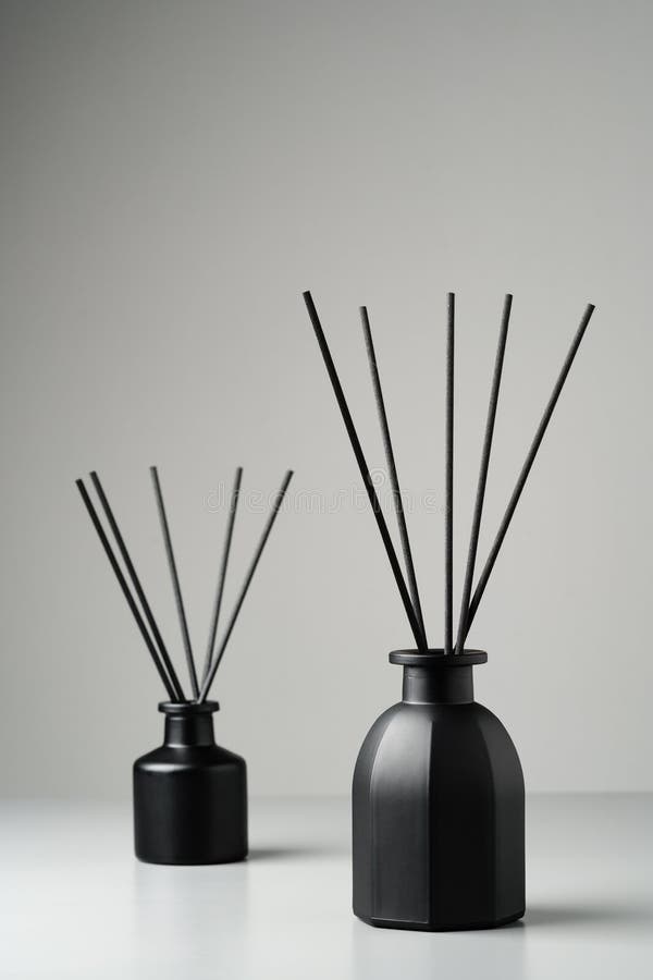 Two Black Reed Diffuser Bottles on a White Surface with Grey Background ...