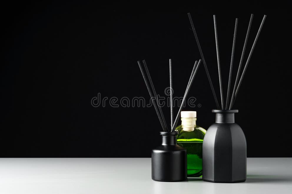 Two Black Reed Diffuser Bottles on a White Surface with Grey Background ...