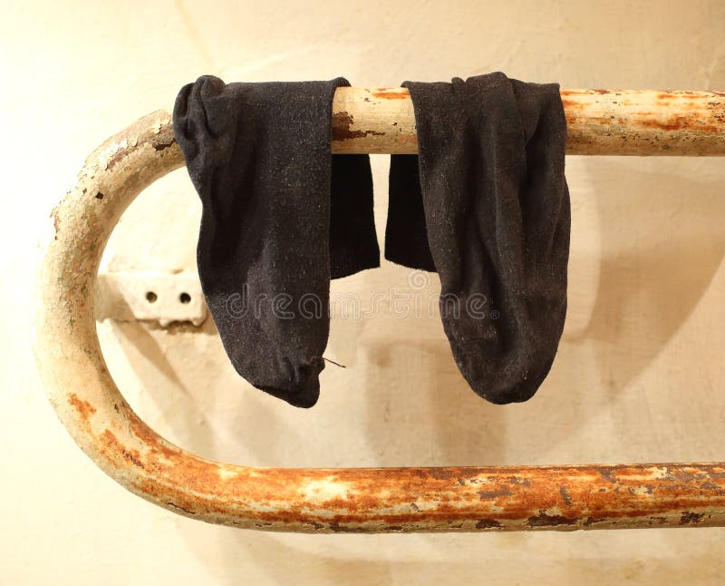 Two Black Socks are Drying on a Hot Pipe with Peeling Paint Stock Image ...