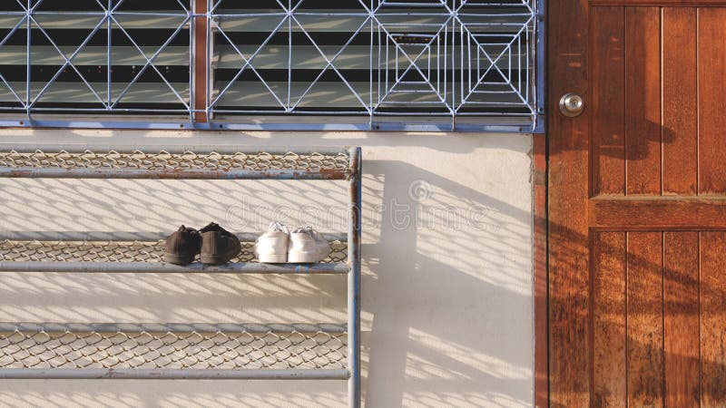 Two Black and White Sneakers on Shoe Rack in Front of Classroom of ...