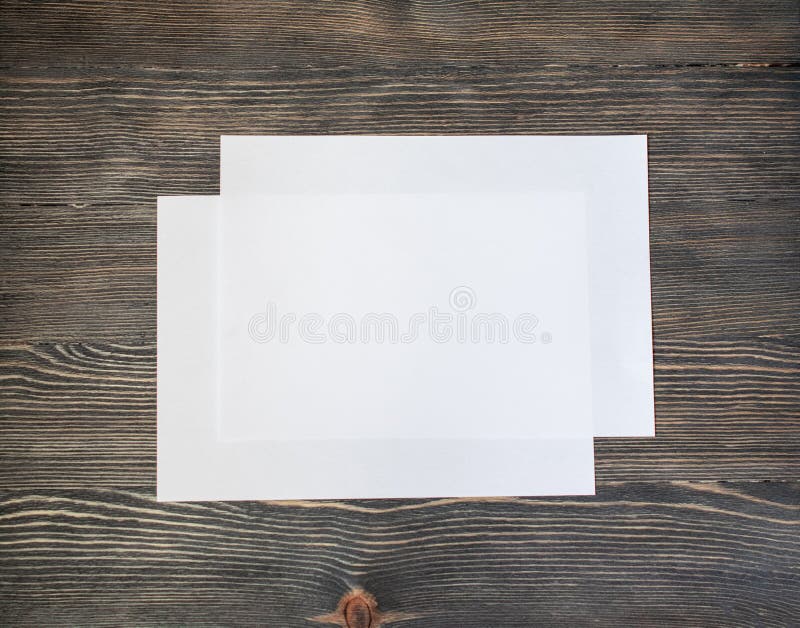 Two Blank White Sheets of Paper on a Wooden Texture Background Stock ...