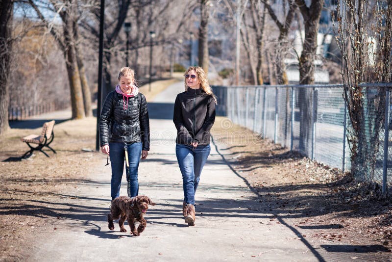 Two Blond Women Walking a Dog Stock Photo - Image of friendship ...