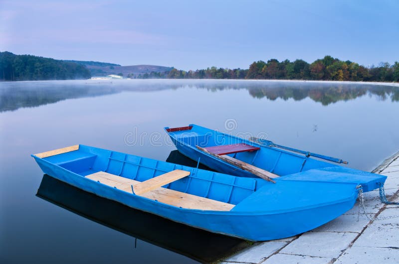 Two blue boats on lake stock photo. Image of leisure - 22993850