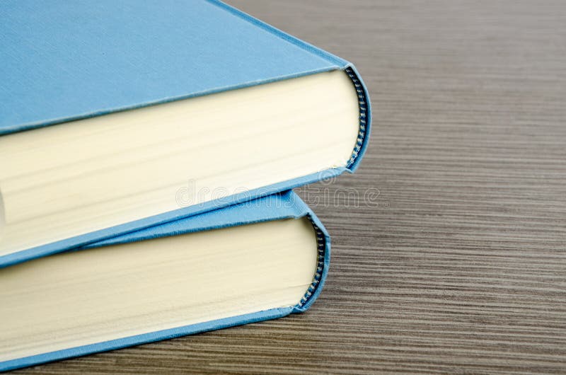 Two Blue Books on a Table with Wooden Texture Stock Photo - Image of ...
