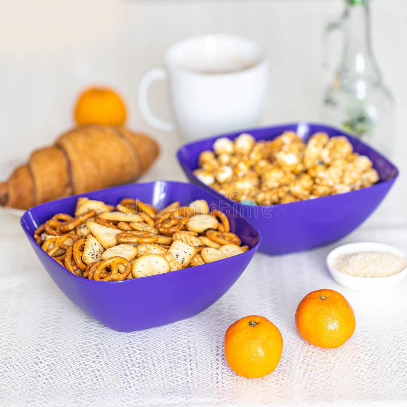 Two Blue Bowls of Snacks and Cookies on Stone Table. Nuts, Chips ...