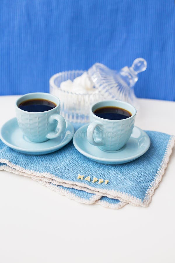 Two Blue Coffee Cups on Blue Napkin with the Words Happy Stock Image ...