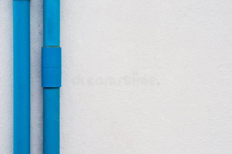 Two Blue PVC Pipes on White Concrete Wall Stock Photo - Image of blue ...
