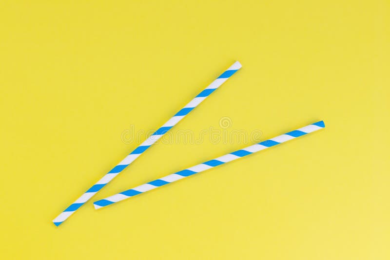 Two Blue Striped Paper Straws on a Yellow Background, with Copy Space ...