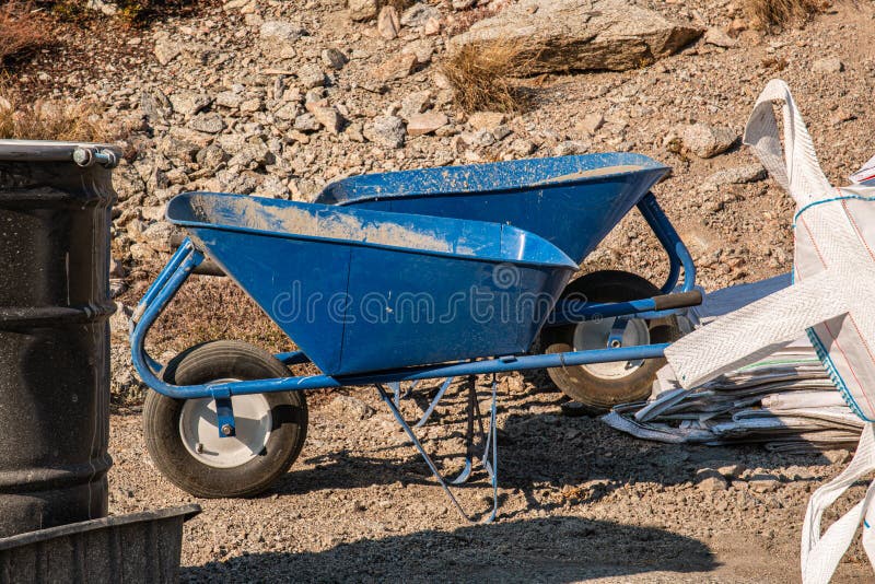 Two Blue Wheelbarrows stock photo. Image of blue, equipment - 229934812