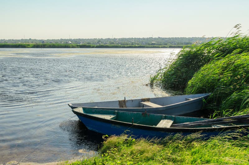 Two boats on river stock photo. Image of light, green - 61480464