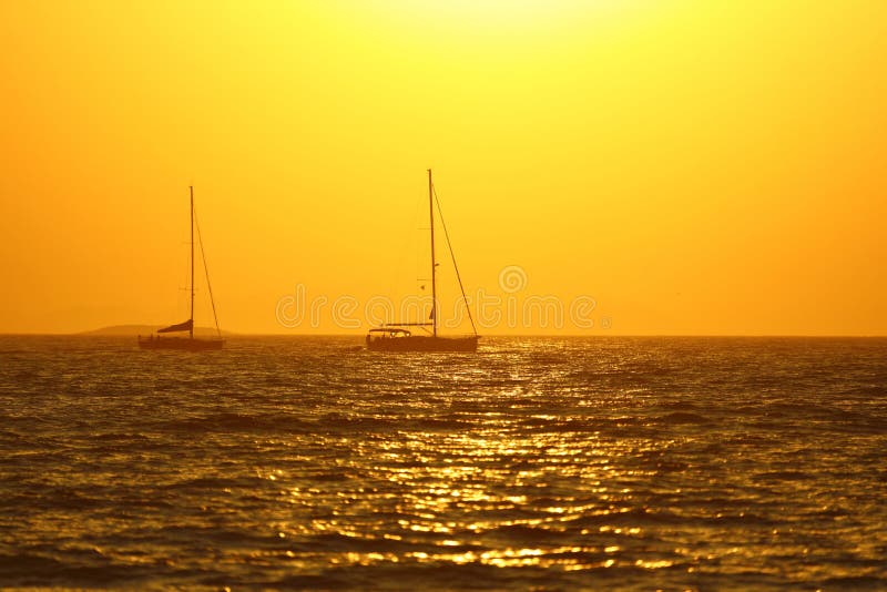 Two Boats Sail on the Sea Under a Golden Sky Stock Photo - Image of ...