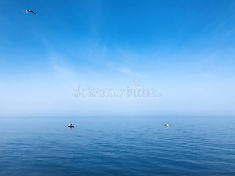 Two boats in the sea stock image. Image of blue, lonely - 129895037
