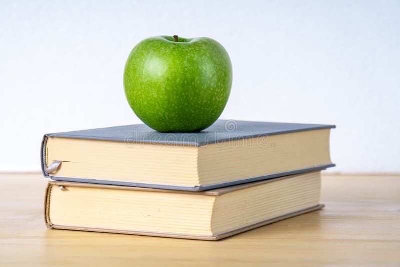 Two Books and Green Apple on the Wooden Table Stock Photo - Image of ...