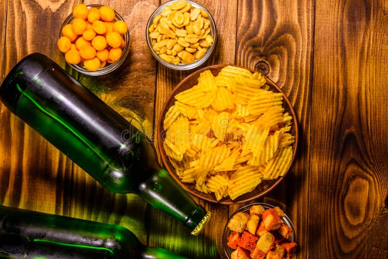 Two Bottles of Beer and Different Snacks on Wooden Table. Top View ...