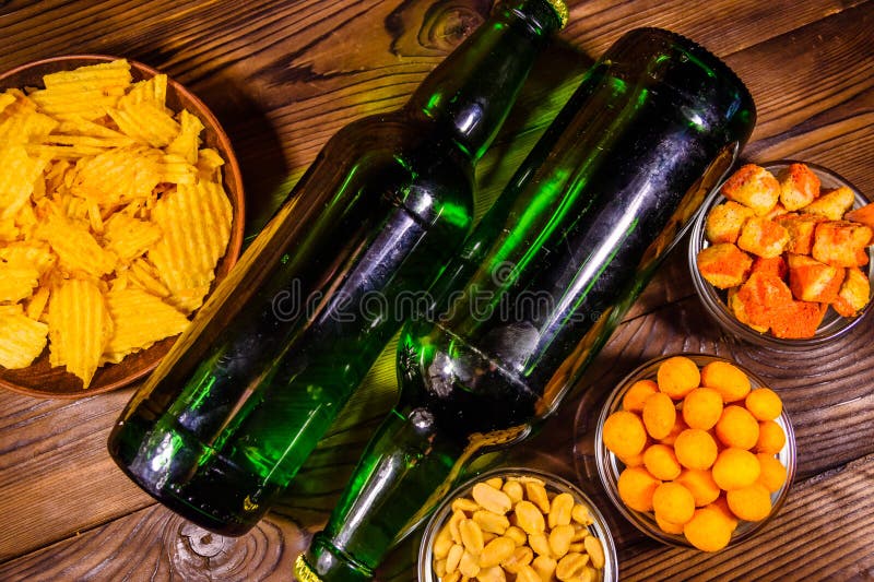 Two Bottles of Beer and Different Snacks on Wooden Table. Top View ...