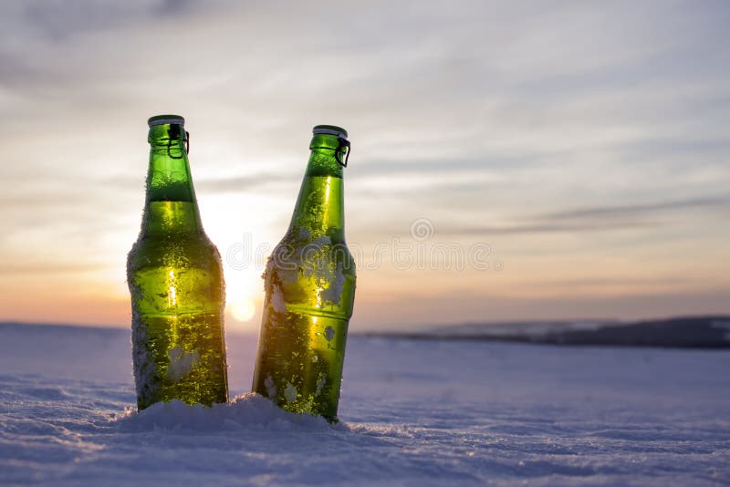 Two Bottles of Cold Beer on the Snow at Sunset Stock Photo - Image of ...