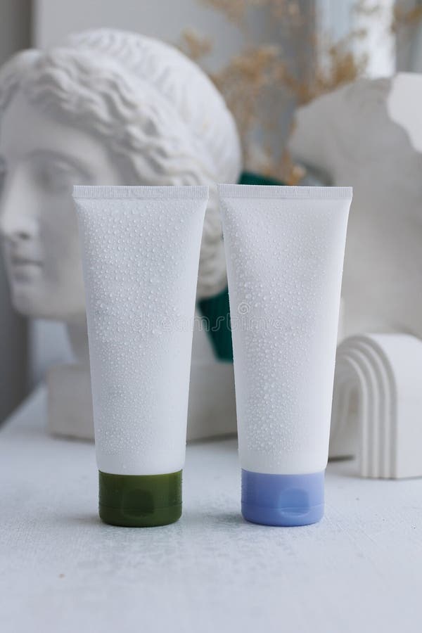 Two Bottles of Moisturizing Lotion are Placed on a Table beside a ...