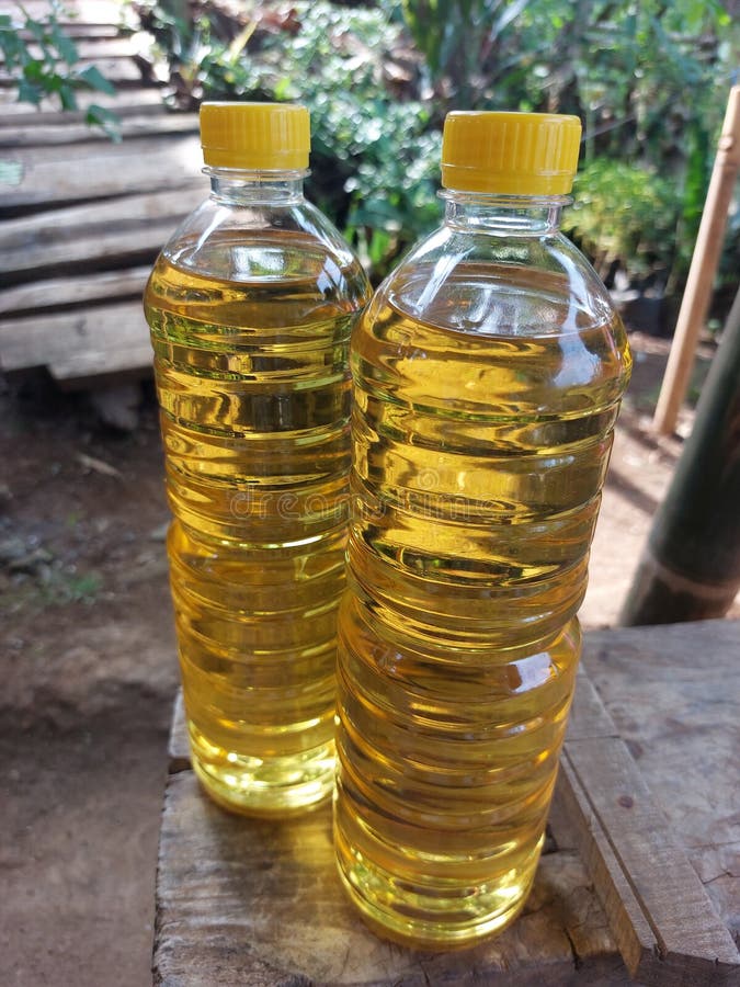 Two Bottles of Yellow Cooking Oil Stock Photo - Image of cooking ...