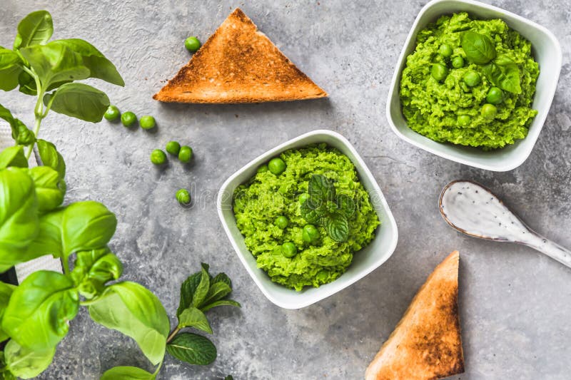 Two Bowls of Pea Puree with Basil, Mint and Roasted Bread on Rustic ...