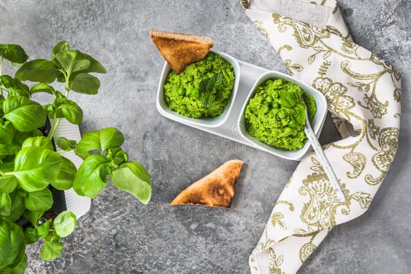 Two Bowls of Pea Puree with Basil, Mint and Roasted Bread on Rustic ...