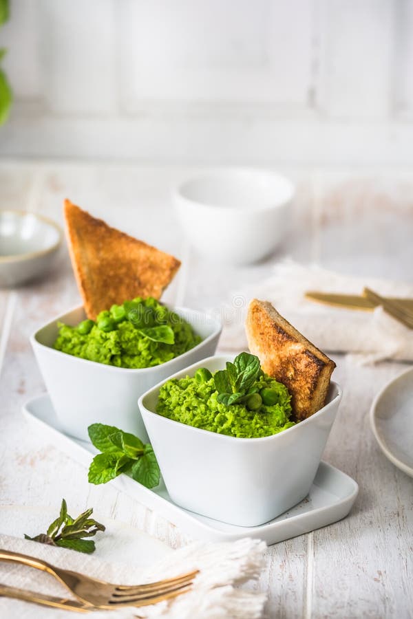 Two Bowls of Pea Puree with Basil, Mint and Roasted Bread on Rustic ...