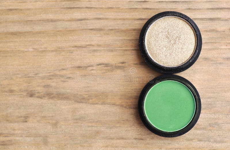 Two Boxes with Green and Gold Eyeshadows on Wood Table Stock Image ...