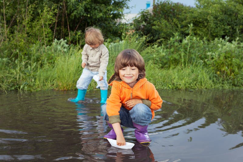 Two boy play in puddle stock image. Image of playing - 93320413