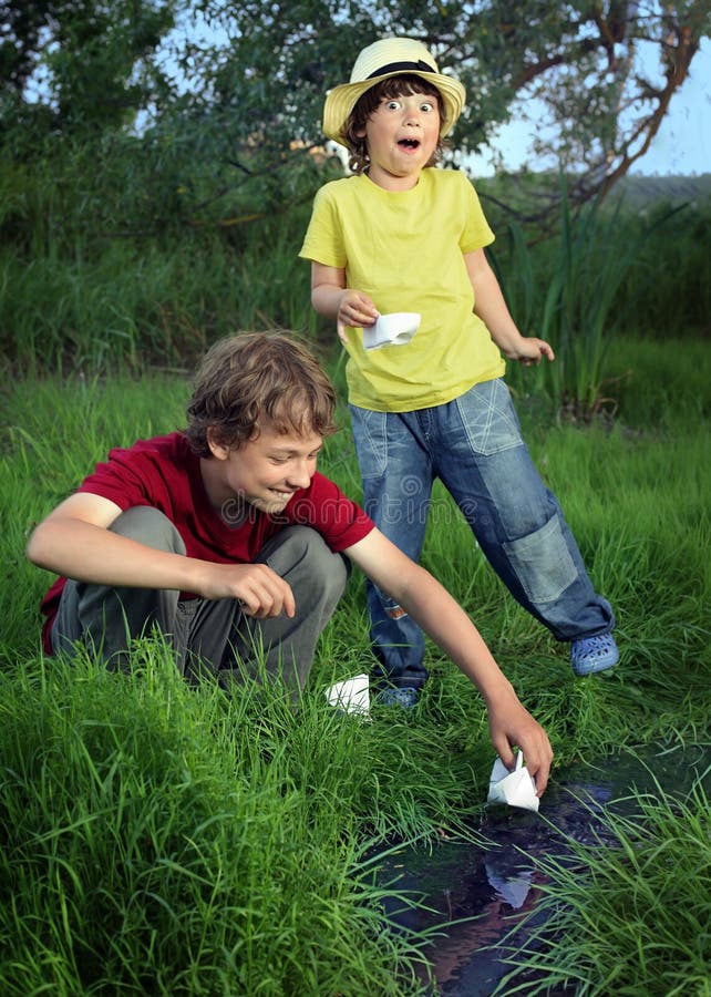 Two boy play in stream stock image. Image of blue, playing - 41325523