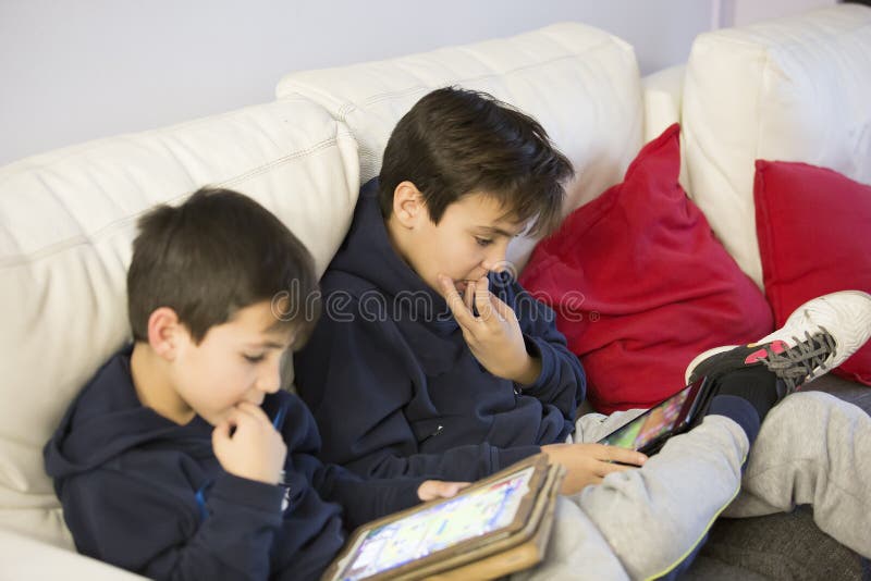 Two Boy Playing with Their Tablets Stock Image - Image of person ...